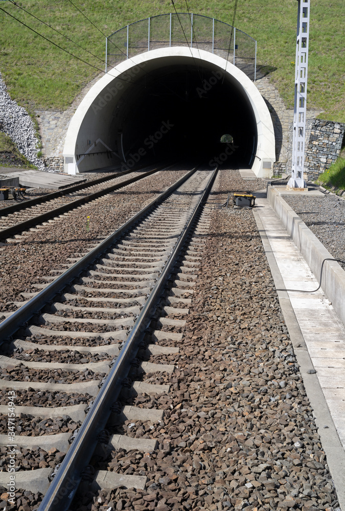 Railway and railroad track is goint into dark and long tunnel ...