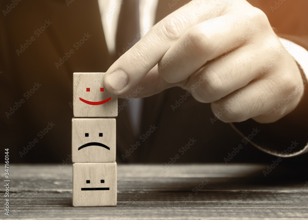 One block with a positive face stands out from the rest of the neutral ...