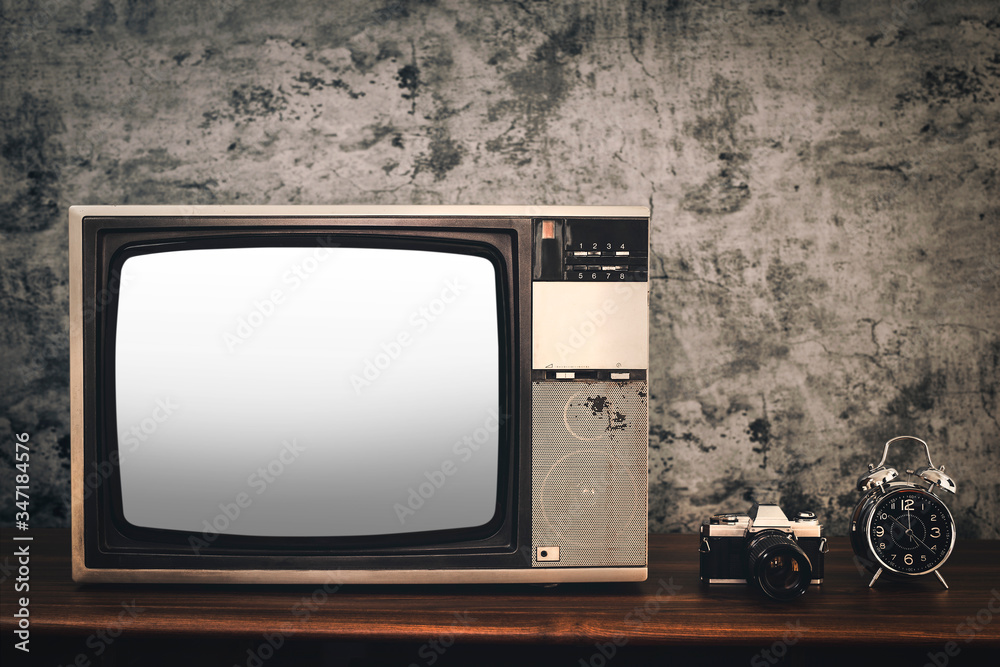 Retro old television with cut out screen, vintage camera and a clock on ...