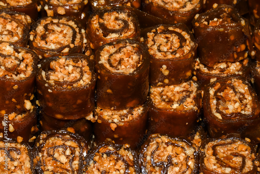 Cevizli sucuk made by dipping a string with walnuts into a grape ...