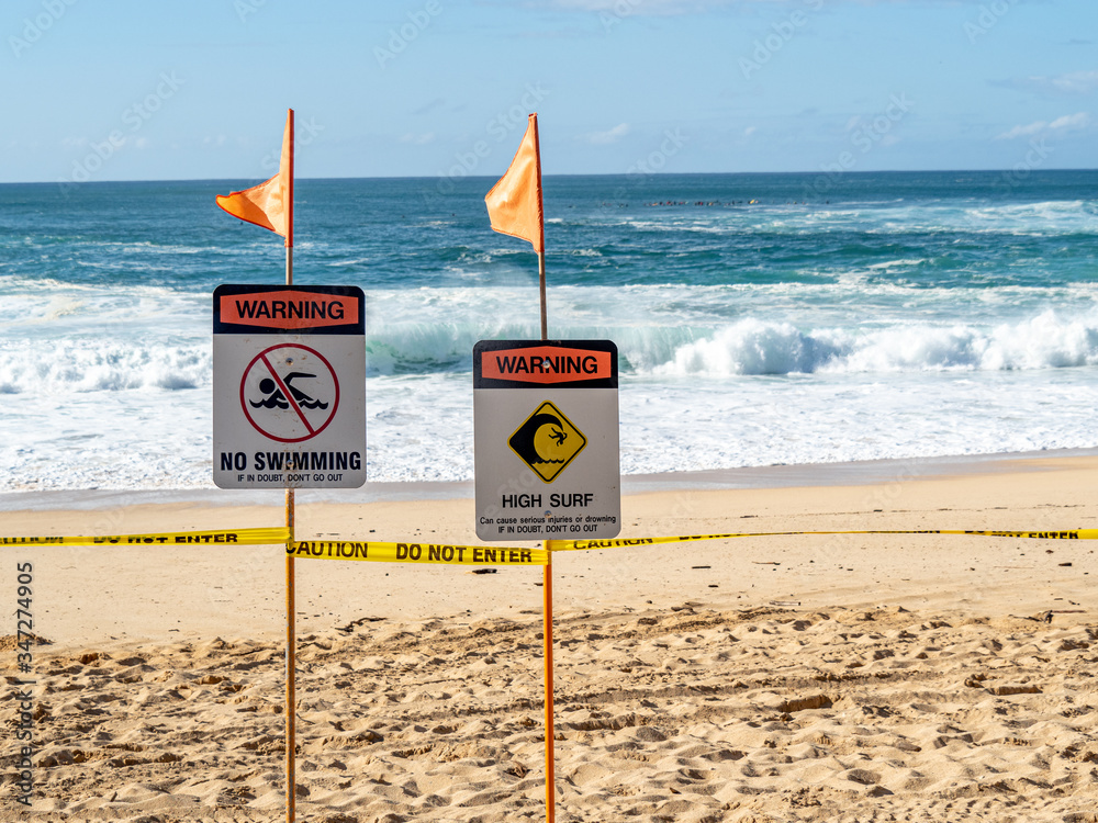 High surf warning signs on Oahu's North shore. Stock Photo | Adobe Stock