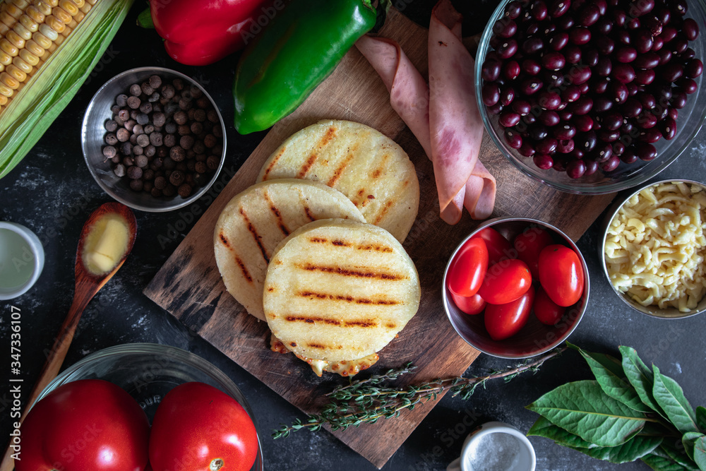 Arepa with vegetables, grains and ham. Typical food of Colombia and ...