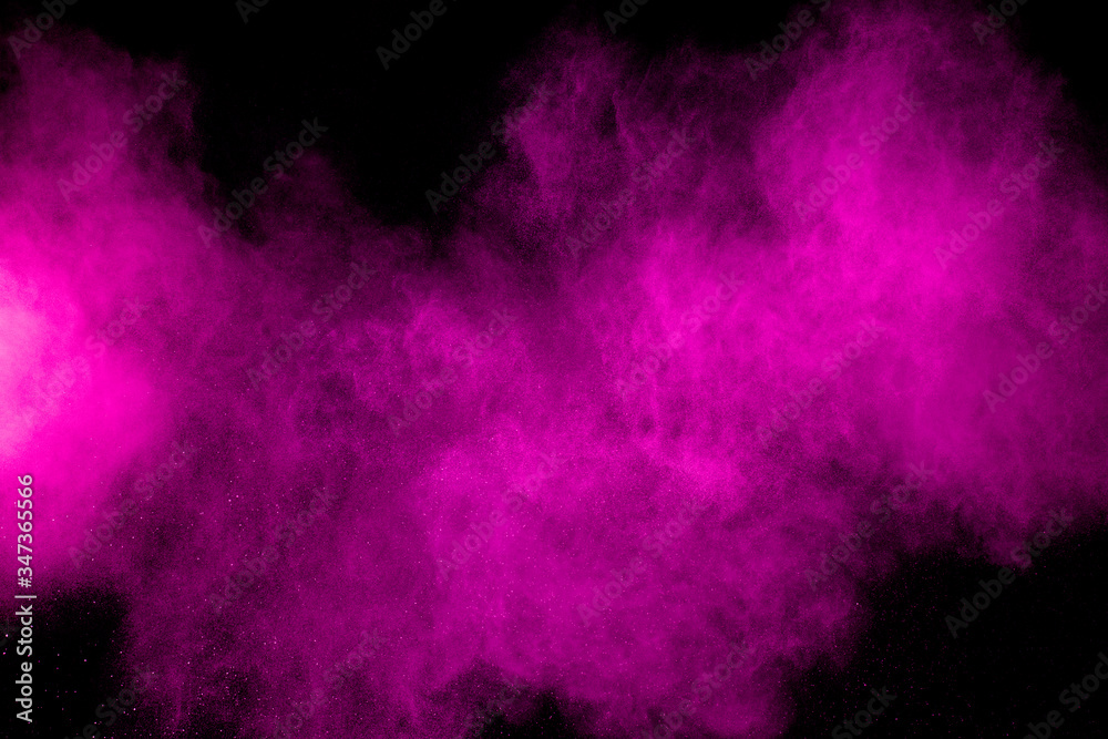 Pink dust particles splash on black background.Pink powder splash ...