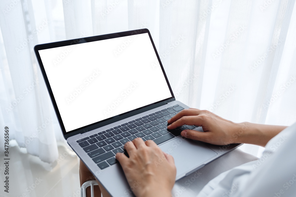 Mockup image of a woman working and typing on laptop computer with ...