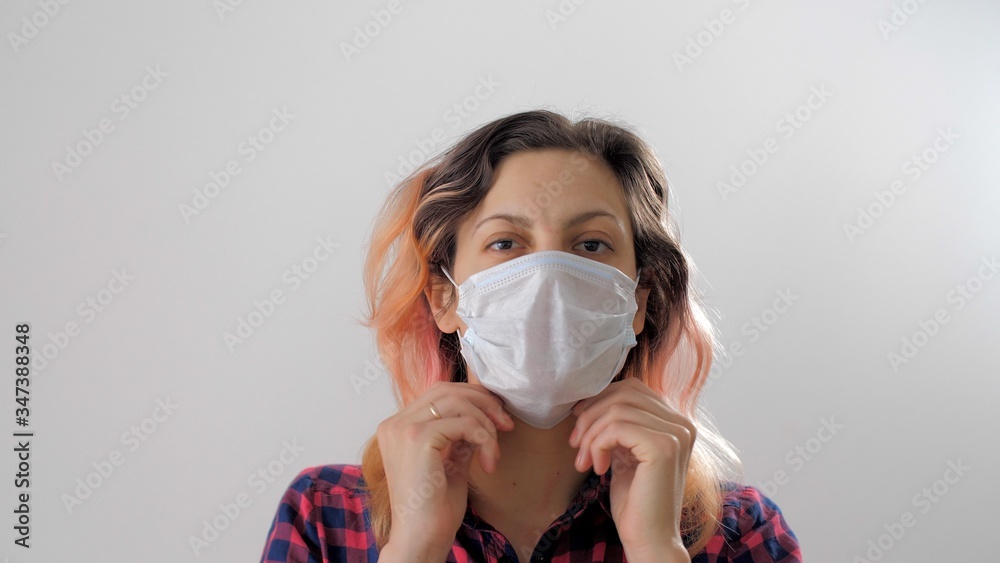 Beautiful young woman puts on or takes off a mask. Portrait of adult ...