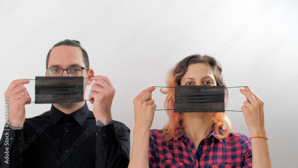 Portrait of modern family, man and woman put on medical masks ...