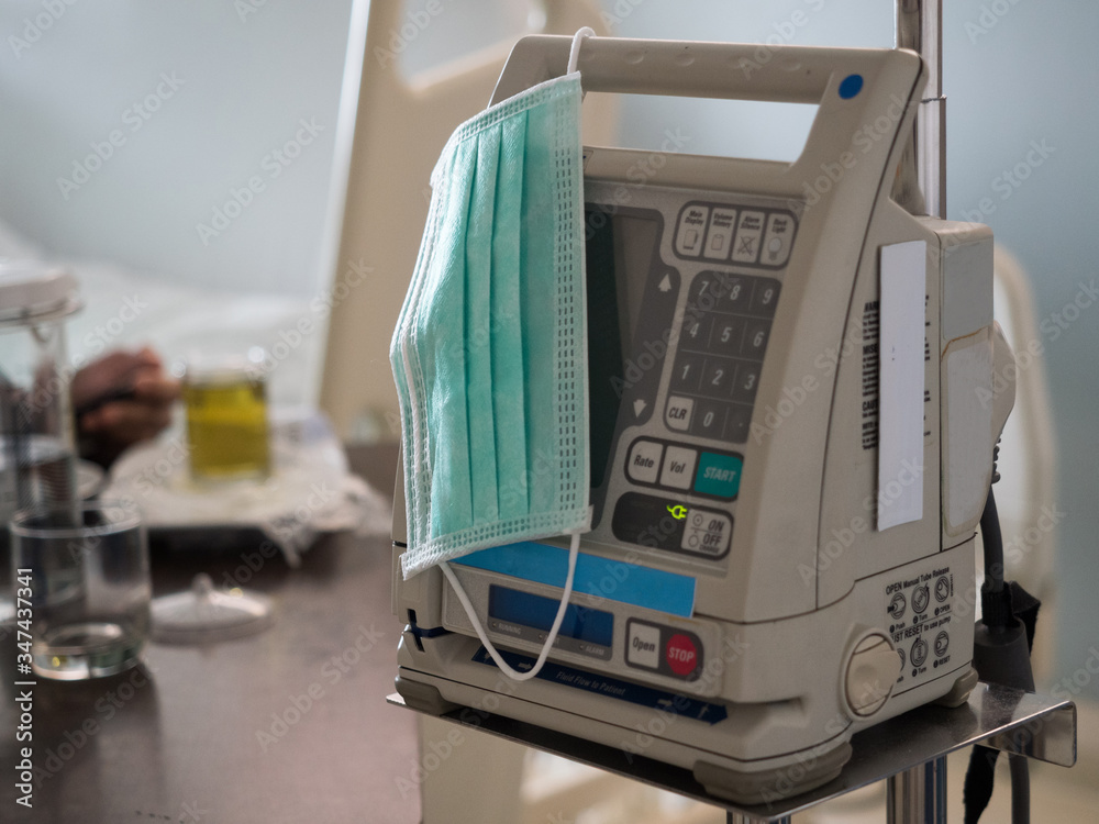 Surgical mask is placed on the medical device. With the patient in the ...