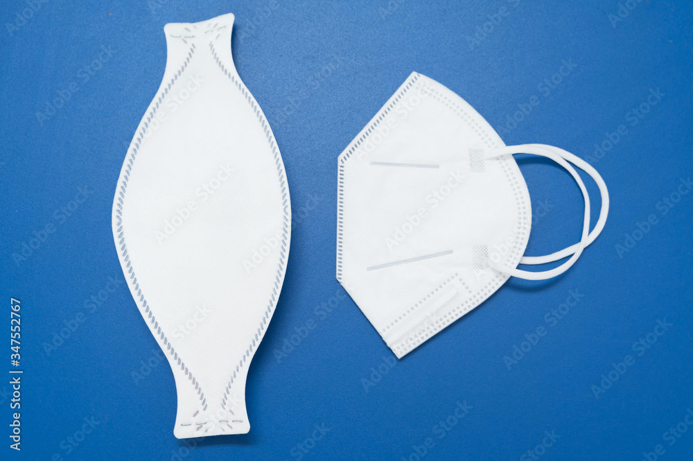 Different medical face mask on blue background.Personal protective ...