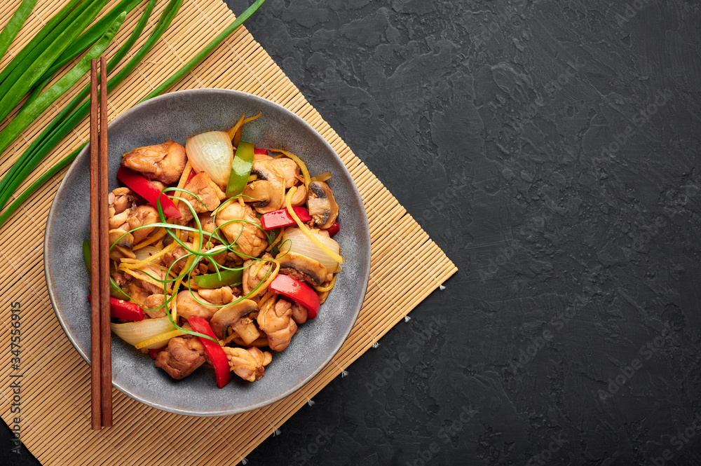Thai Ginger Chicken or Gai Pad King in gray bowl at black slate ...