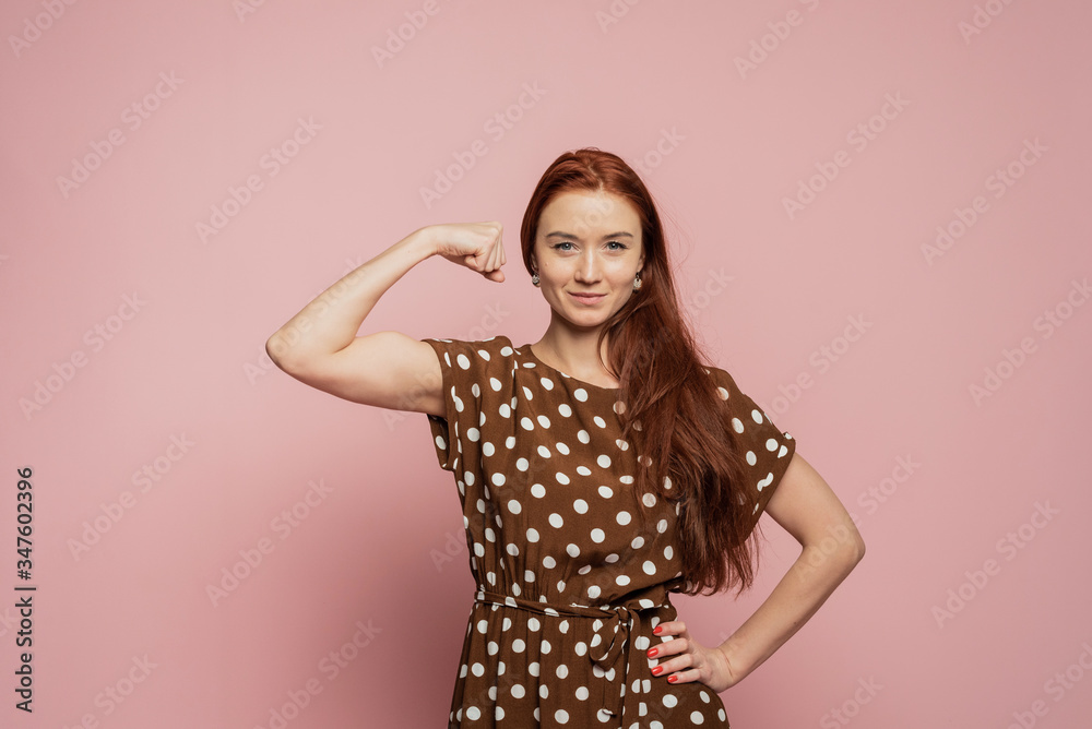 redhead girl with the biceps. A strong girl with beautifull red hair on ...