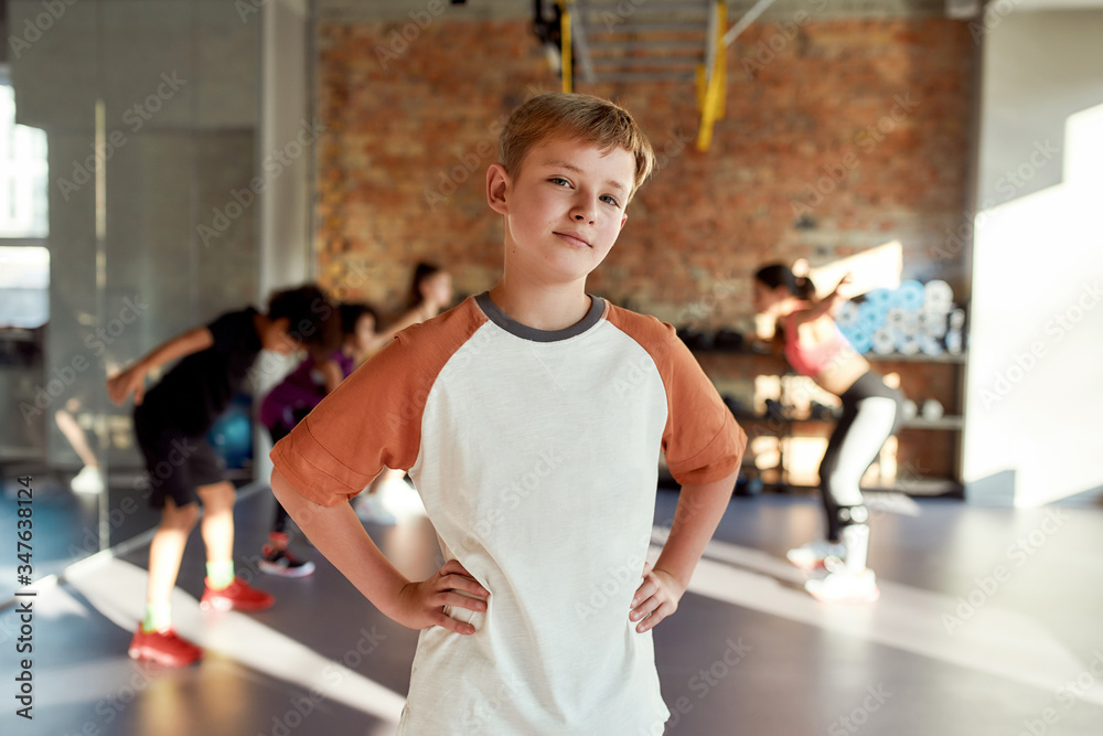 Little sportsman. Portrait of a boy looking at camera before warming up ...