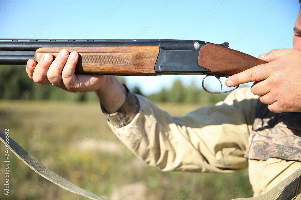 hunter aiming with hunting rifle close up. Stock Photo | Adobe Stock