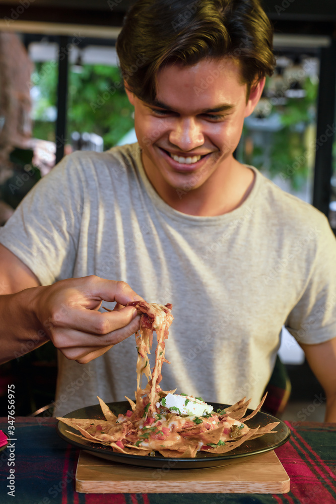 Foto de mexican food background of tortilla nachos chip with melted ...