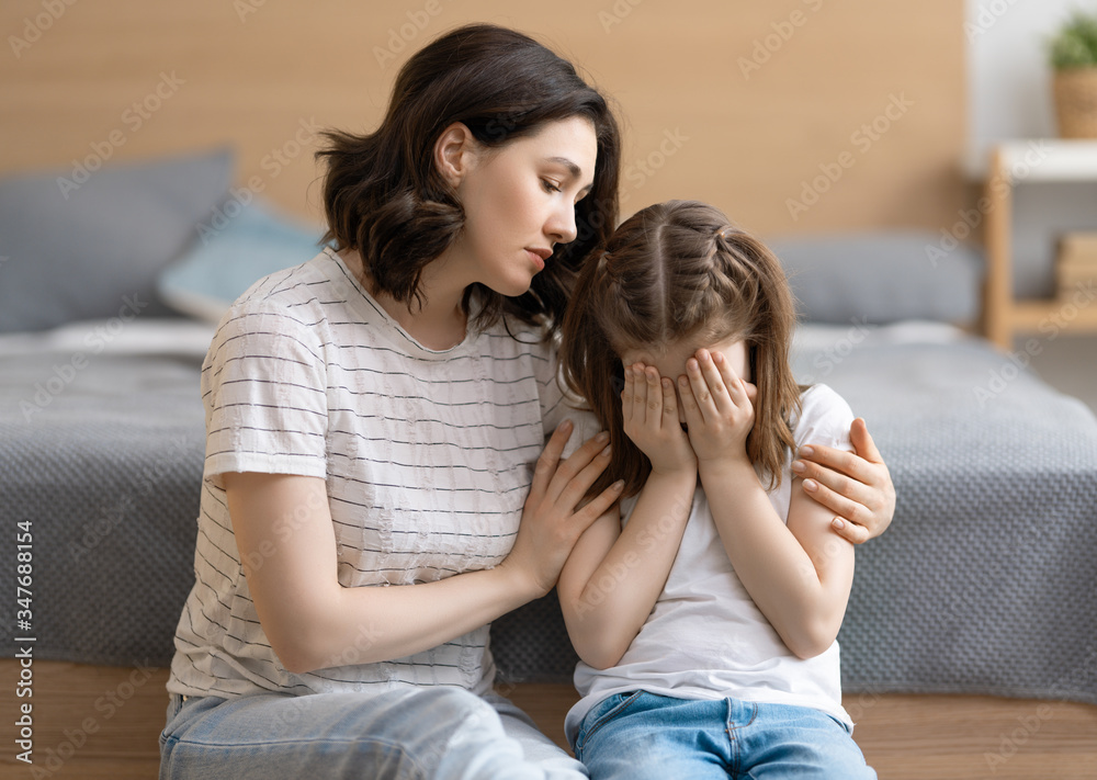 Mother is feeling sorry for a crying child. Stock Photo | Adobe Stock