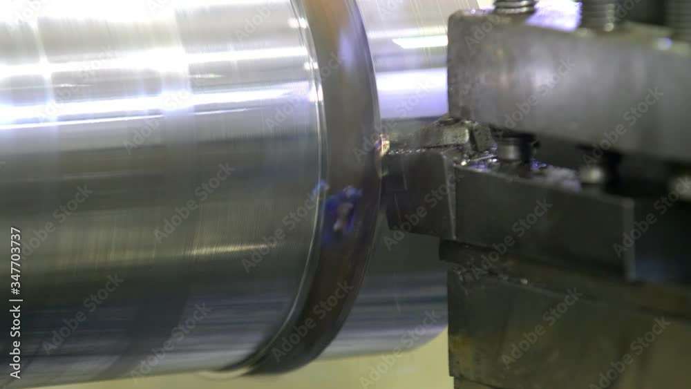 The lathe produces the metal part at the factory. Processing of the ...