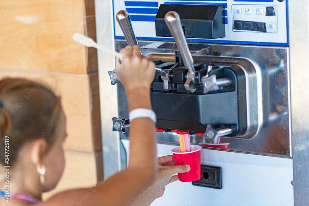 ice cream from an ice cream machine in the manufacturing process Stock ...