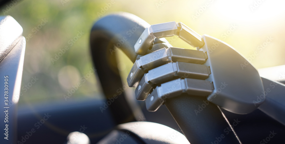 Robot arm on a steering wheel. Artificial intelligence drives a car ...