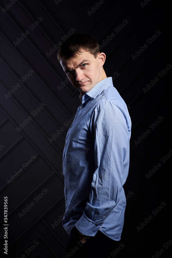 Young brunette man, wearing light blue shirt, posing for picture in ...