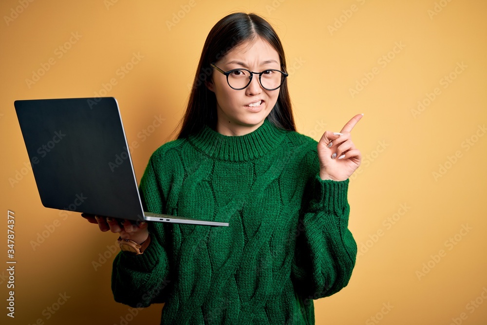 Young asian business woman wearing glasses and working using computer ...