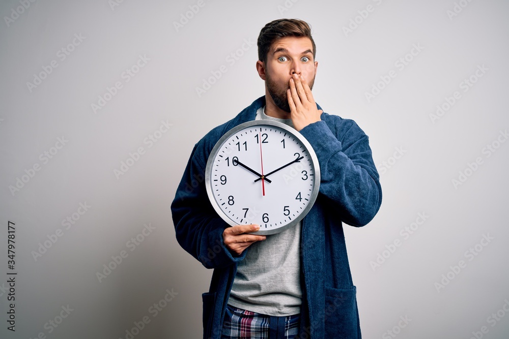 Young blond man with beard and blue eyes wearing pajama holding big ...