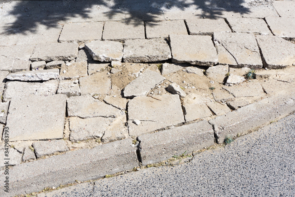 Damaged pavement. Urban construction background. Road curb texture ...