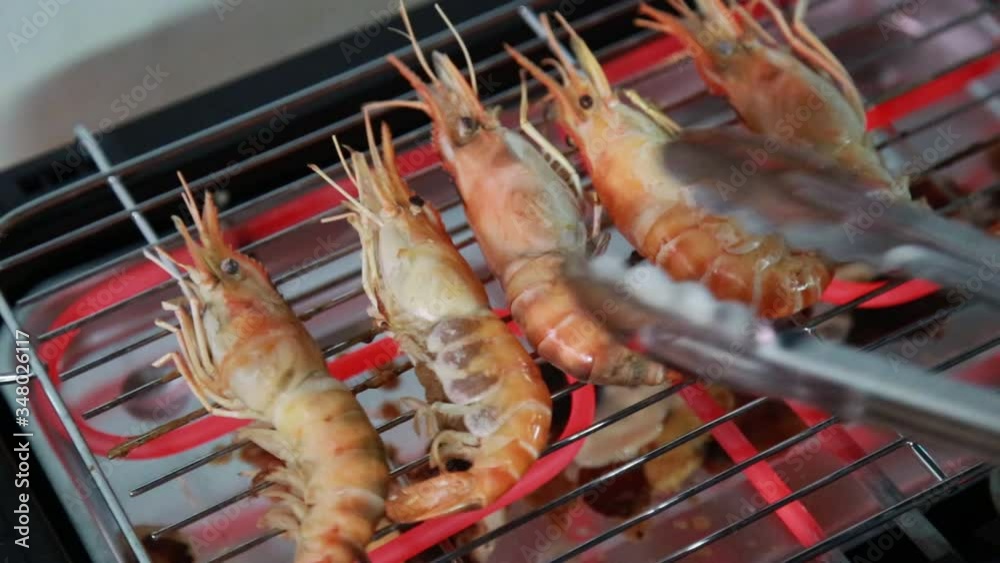 Cooking grilled shrimp with an electric grill by grilled on steel ...