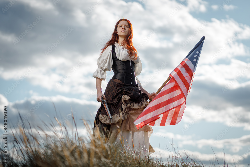 Girl in historical dress of 18th century with flag of United States ...