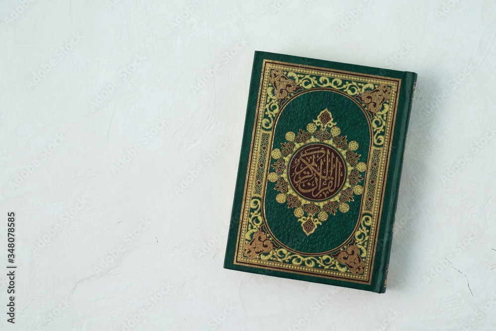 Holy Quran with written arabic calligraphy meaning of Al Quran on white ...