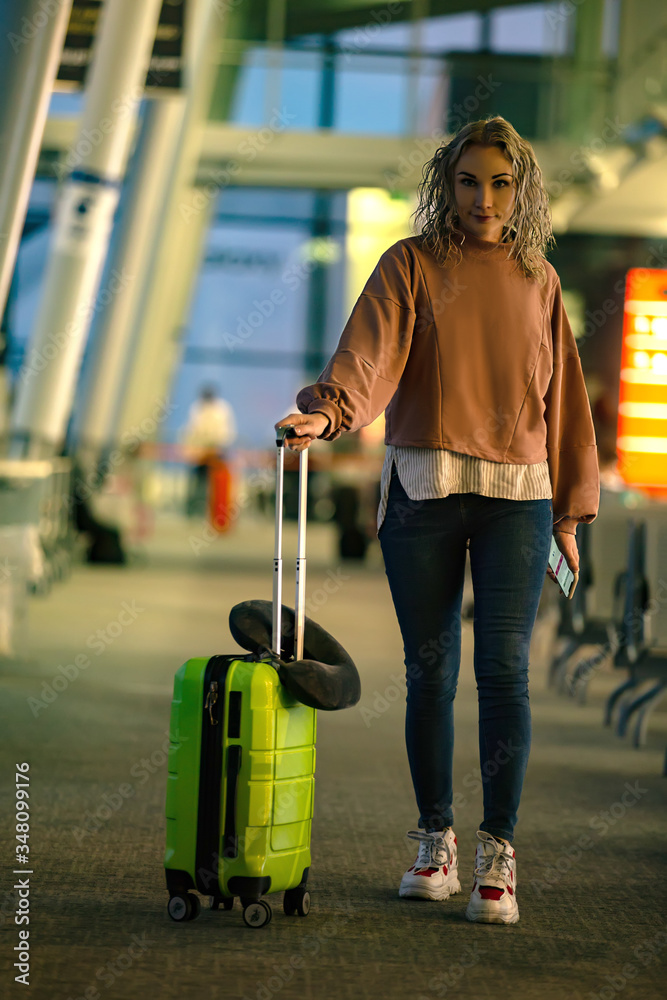 Sexy blonde at the airport with a boarding pass and a suitcase Stock ...
