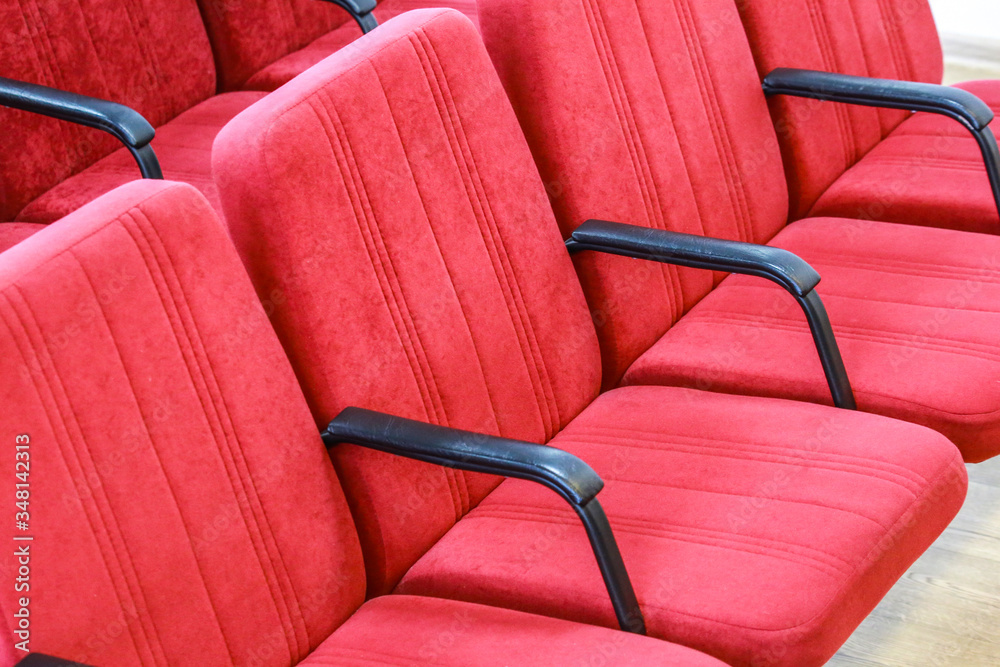 Red chair close-up. Rows seats in empty movie theater. Conference room ...