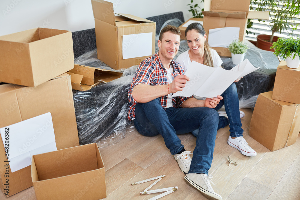 Young couple moving with blueprint Stock Photo | Adobe Stock