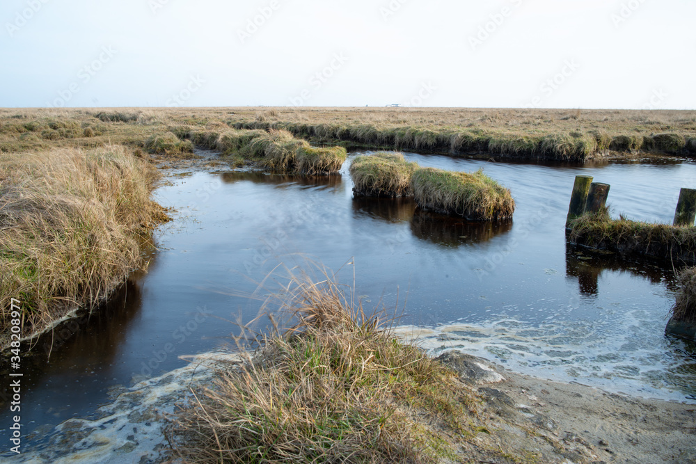 water basin in the salt marshes in st peter ording on the german coast ...