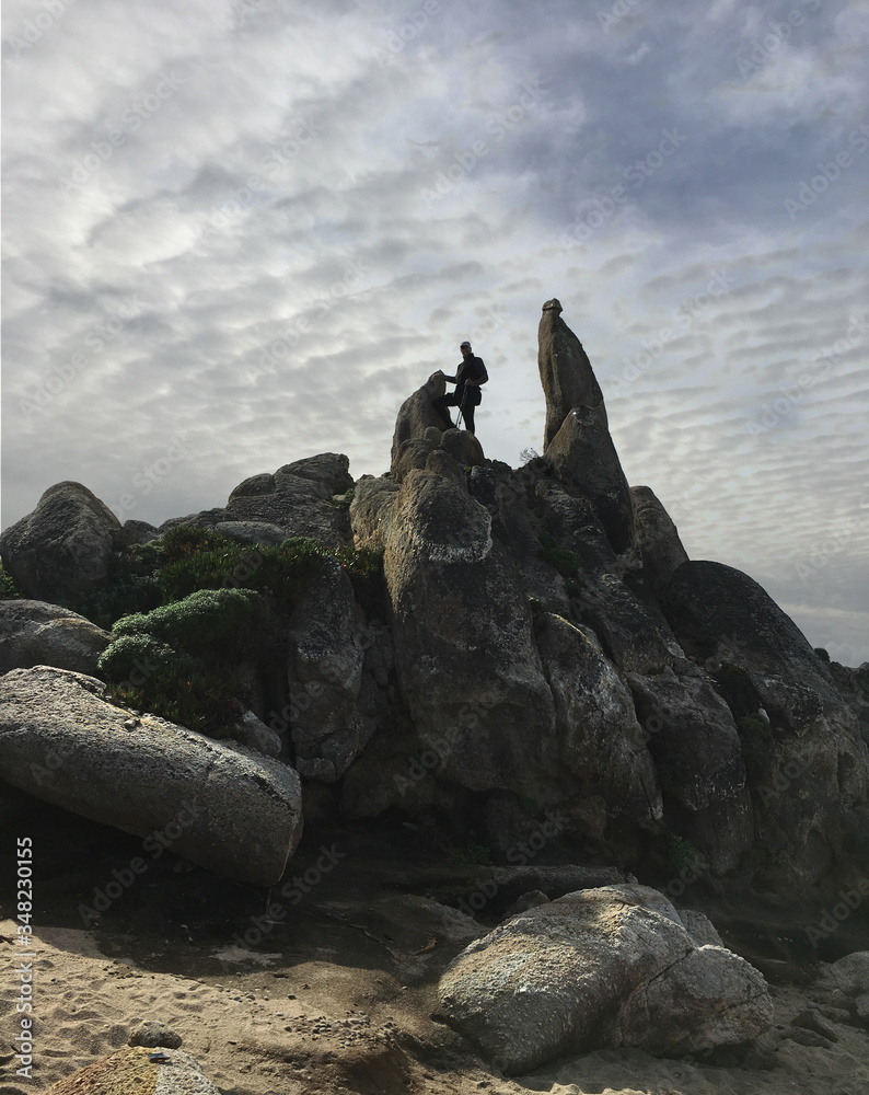 Man and environment Carmel California Rocky Promontory at Beach Winter ...