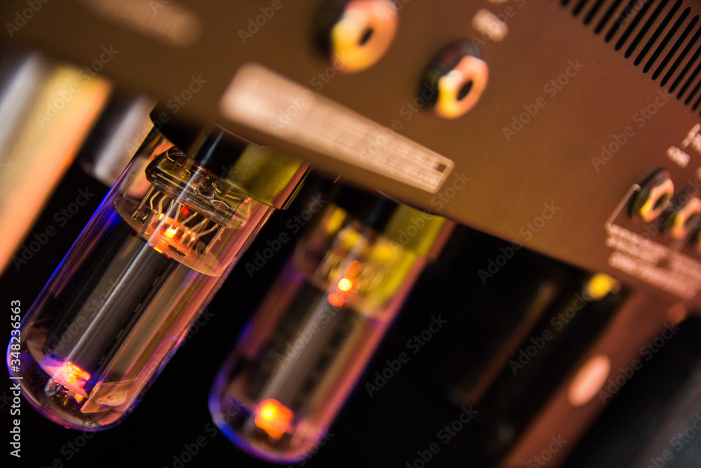 Electrical light buld with purple, yellow, orange light and wire inside ...