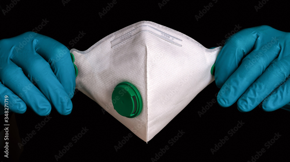 Male hands holding a face mask ffp3 / N95 (personal protective ...
