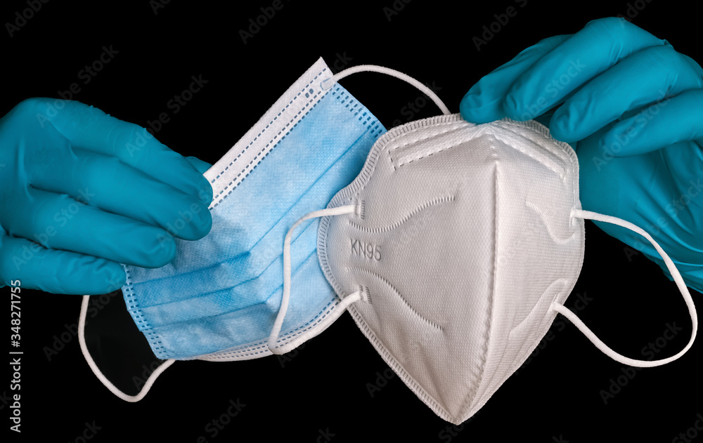 Male hands wearing medical gloves and putting on a medical disposable ...