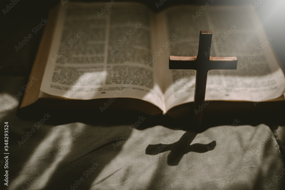 Crucifixion of Jesus christ ,cross with the holy bible at sunlight ...