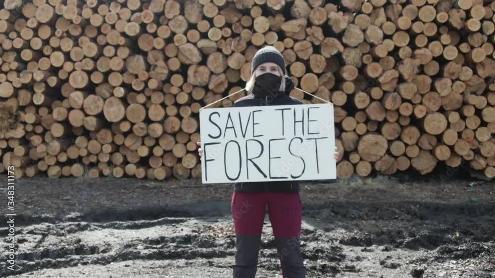save forest poster, dolly zoom aerial. Young activist holding ecology ...