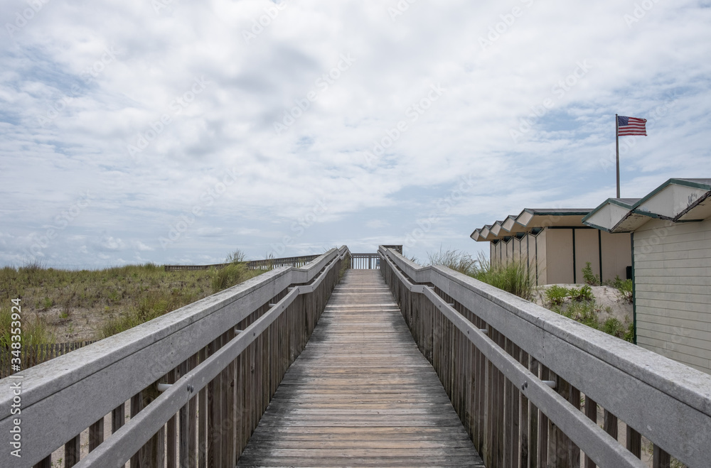 Outdoor wooden boardwalk walkway, with sky and cloud background. Beach ...