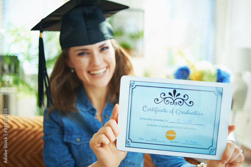 woman with graduation cap showing Certificate of Graduation Stock Photo ...