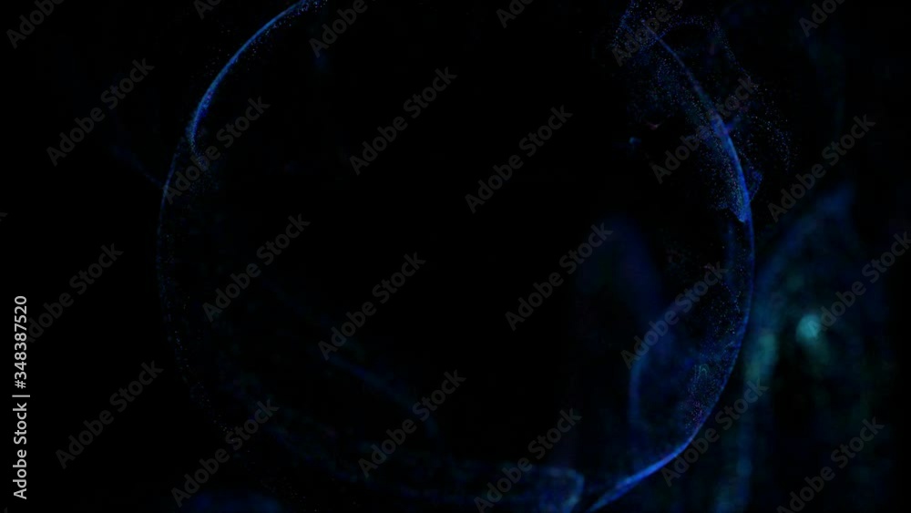 Vidéo Stock stream of blue luminous particles underwater on black ...