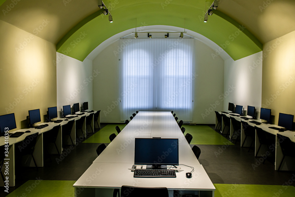 office room with computer tables with keyboard and mouse with a board ...