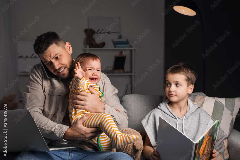 Working father with little children late at home Stock Photo | Adobe Stock