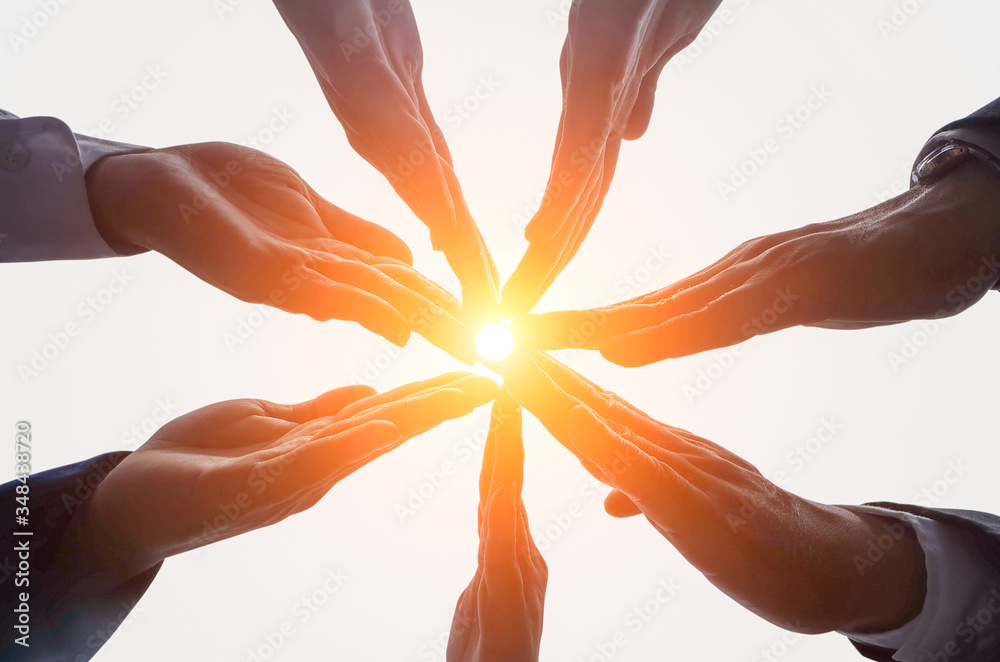 Close up image of successful team join hands up to the sky like a pizza ...