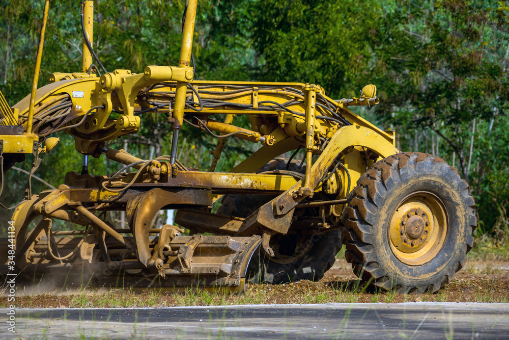 Close up of Motor grader clearing and leveling construction site ...