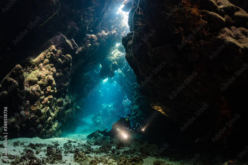 typical underwater cave in a red sea reef with an underwater ...