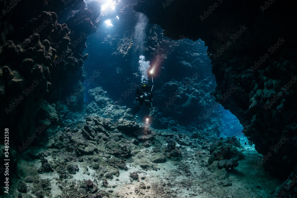 typical underwater cave in a red sea reef with an underwater ...