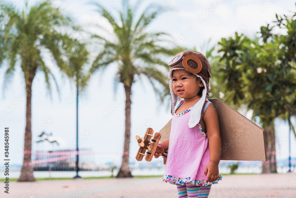 Happy Asian funny child or kid little girl smile wear pilot hat and ...