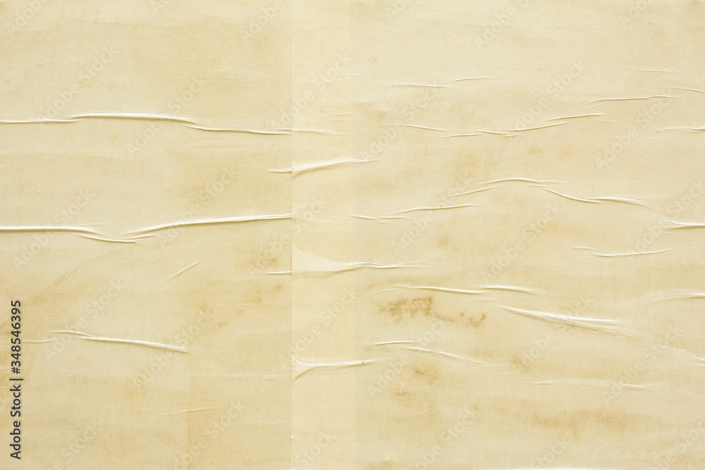 Old crumpled beige brown paper poster glued on billboard. Blank vintage ...