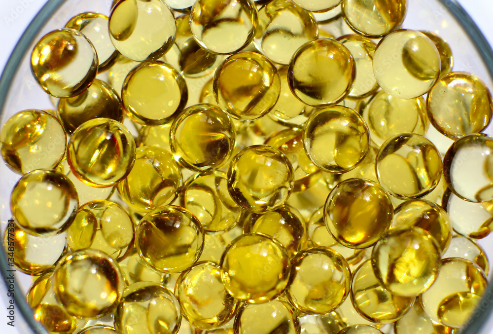 Fish oil pills. Transparent round capsules of vitamin as an abstract ...